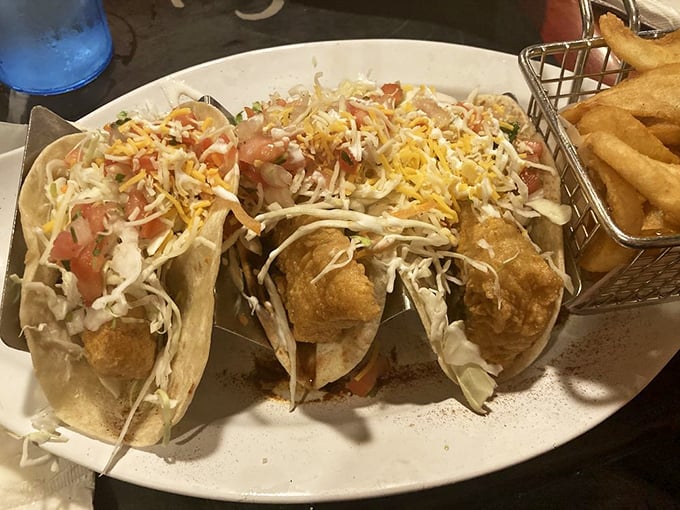 Fish tacos done right: crispy mahi nestled in soft shells, topped with enough cheese and slaw to make your taste buds throw a spontaneous fiesta.