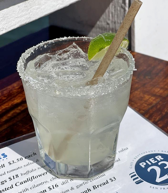 That margarita with its salty rim is basically liquid sunshine in a glass with a lime garnish.