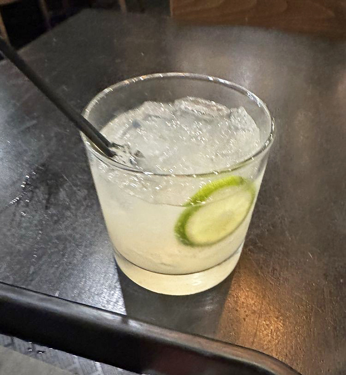 A proper margarita with a lime wheel perched on the rim like it's enjoying the view. The perfect palate cleanser between bites of smoky perfection.