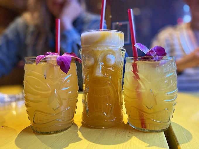Tiki-inspired glasses holding what might be the world's most photogenic margaritas. The middle one looks like it's judging your drink order.