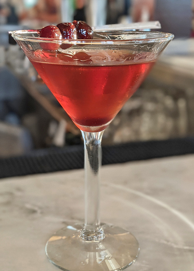 This isn't just a cocktail&mdash;it's liquid ruby, garnished with cherries that have found their perfect forever home. Happy hour, indeed.