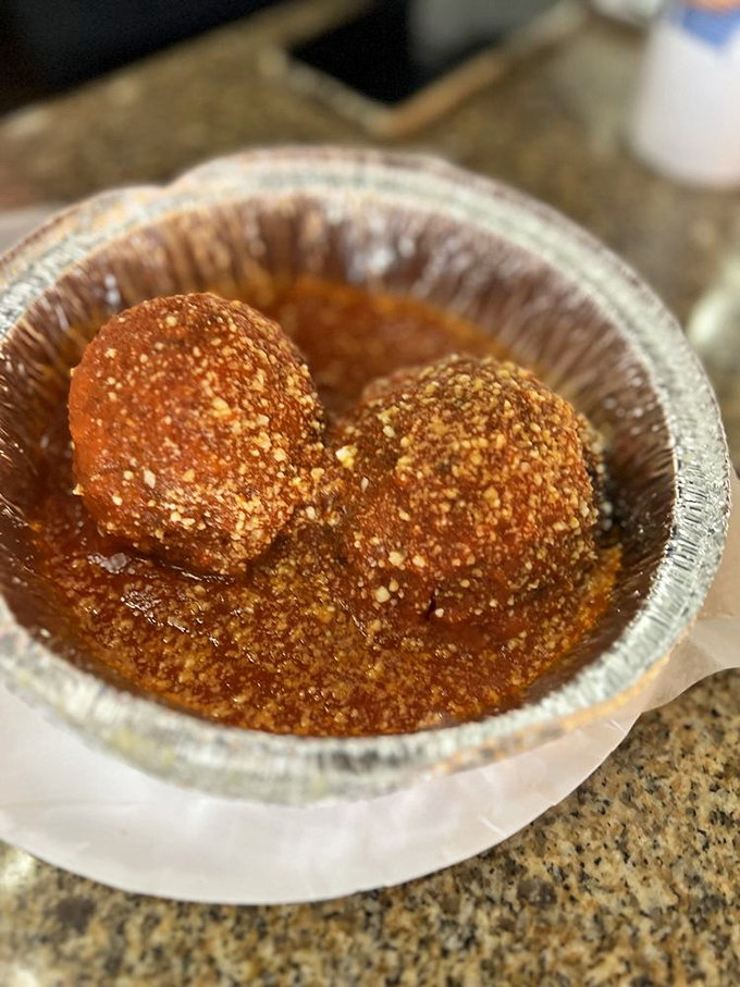 These meatballs aren't just swimming in sauce; they're doing the backstroke in a pool of flavor that would make your Italian grandmother weep with joy. 