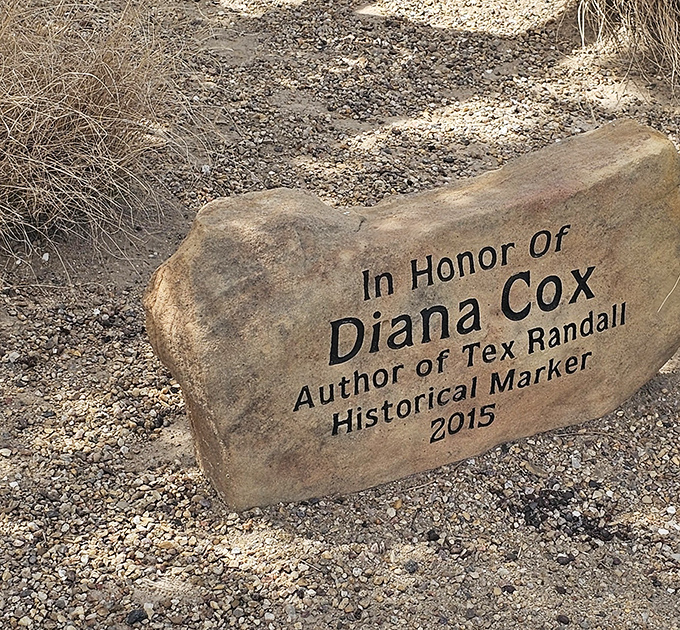 This memorial stone honors those who helped preserve Tex's legacy, creating a touching tribute to community spirit and roadside americana.