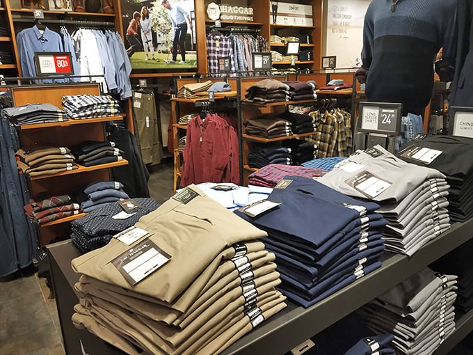 Men's pants, meticulously folded and stacked higher than my retirement dreams. Khakis for days, literally.