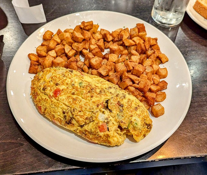 This fluffy omelet, paired with perfectly seasoned home fries, proves that breakfast potatoes deserve just as much attention as the eggs themselves.