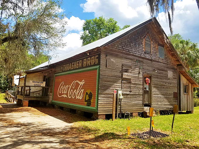 The Thrasher Bros. building wears its vintage Coca-Cola advertisement like a badge of honor, a faded reminder of simpler commercial times. 