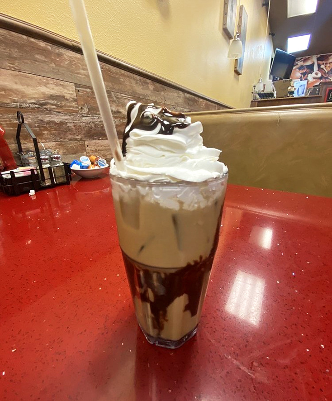 This milkshake isn't just a drink—it's architecture with whipped cream, chocolate, and a straw that's purely decorative.