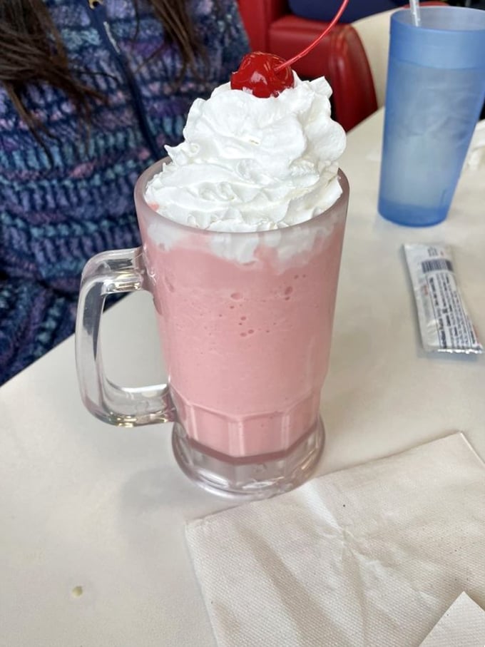 That strawberry milkshake isn't just pink&mdash;it's the exact color of childhood summer memories, topped with a cloud of whipped cream and nostalgia.
