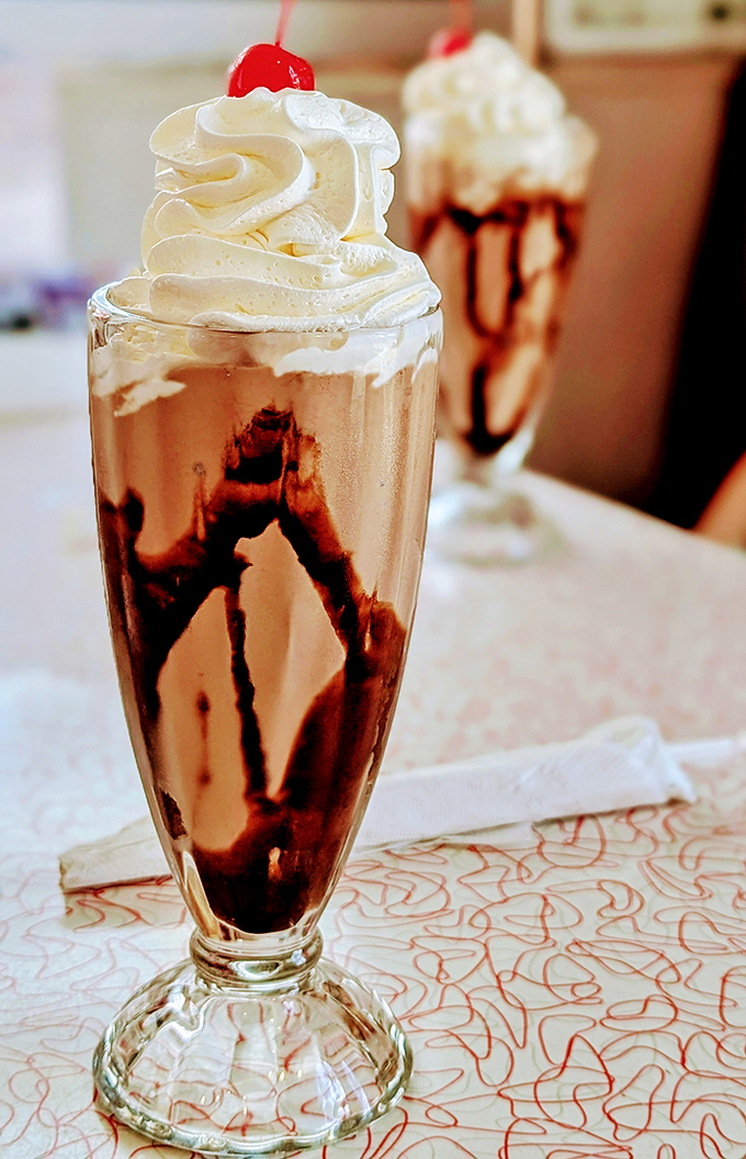 This isn't just a milkshake&mdash;it's a tower of nostalgia in a glass, where chocolate syrup, ice cream, and whipped cream come together for a standing ovation.