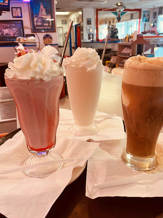 Milkshakes so thick they defy gravity, topped with whipped cream mountains that deserve their own zip code.