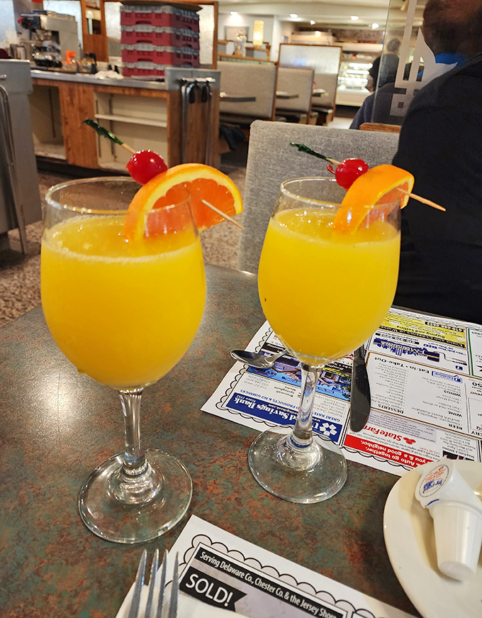 Mimosas at the diner&mdash;where breakfast meets celebration and orange juice finally fulfills its highest purpose, served with those little plastic swords of adulthood.