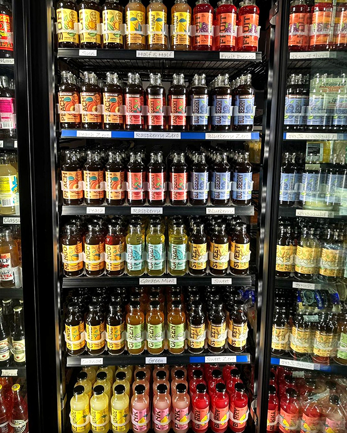 A refrigerator case that's basically a liquid library of Midwest flavors—these bottled teas and sodas are what vending machines dream of becoming.