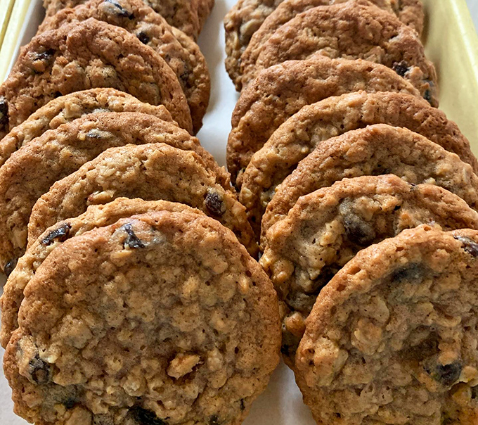 Oatmeal raisin cookies lined up like delicious soldiers &ndash; crisp edges, chewy centers, and enough heft to make you feel like you're almost eating breakfast.
