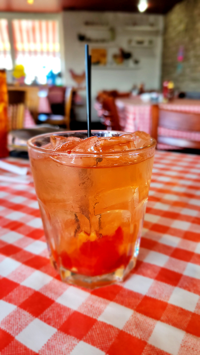 That's not just any cocktail &ndash; it's an Old Fashioned sitting pretty on a checkered tablecloth, waiting to wash down all that glorious fried goodness.