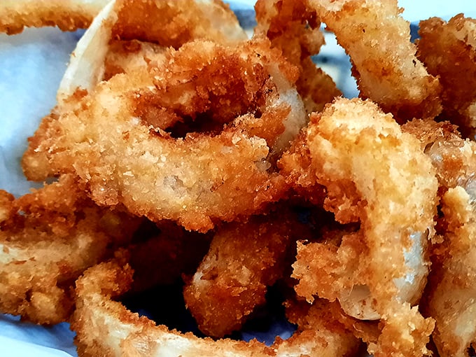These aren't just onion rings; they're crispy golden halos that deserve their own hymn of praise.