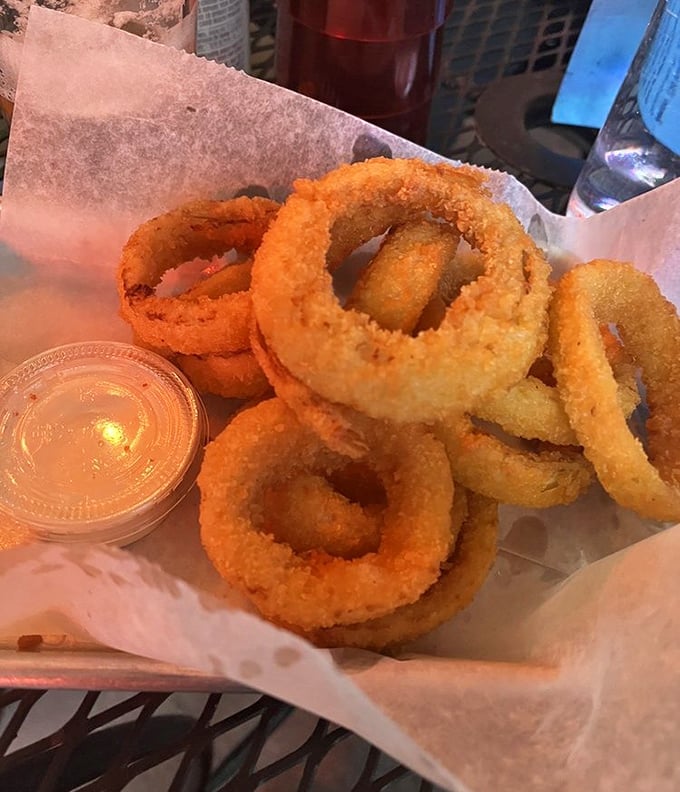 Crispy, golden onion rings stacked like delicious jewelry&mdash;the perfect sidekick to pizza that deserves its own moment in the spotlight.