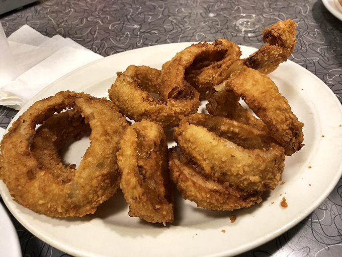 Onion rings with architectural integrity that would impress Frank Lloyd Wright. Crispy, golden halos of happiness.