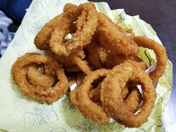 Golden, crispy onion rings that shatter with each bite. These aren't sides - they're the supporting cast that sometimes steals the scene.