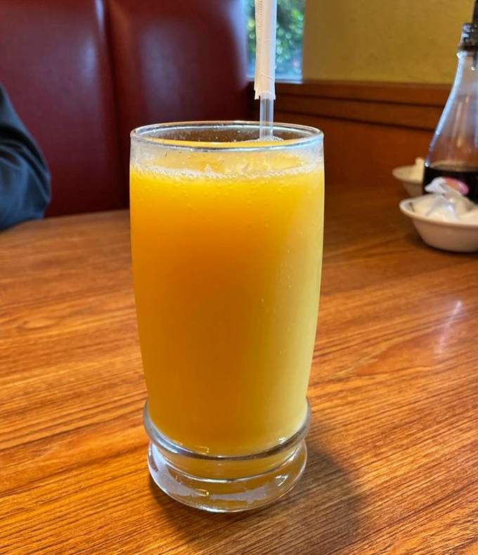 Orange juice in a proper glass &ndash; because sometimes vacation breakfast deserves more dignity than a tiny plastic thimble of citrus concentrate.