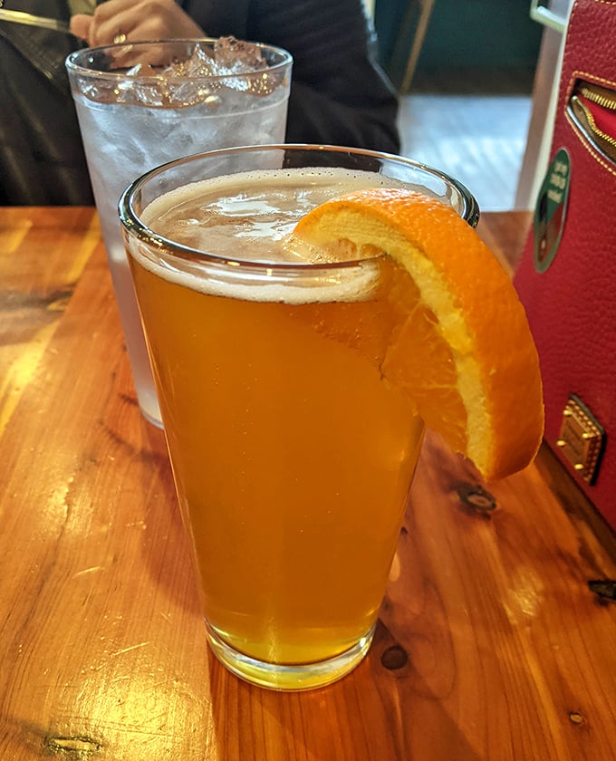 Even the beverages get special treatment here&mdash;a craft beer garnished with orange, because when you're eating like royalty, your drink deserves a crown too.