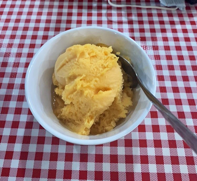 This isn't just mashed potatoes—it's a golden cloud of buttery comfort waiting to cushion the flavor impact of whatever barbecue you've wisely ordered.