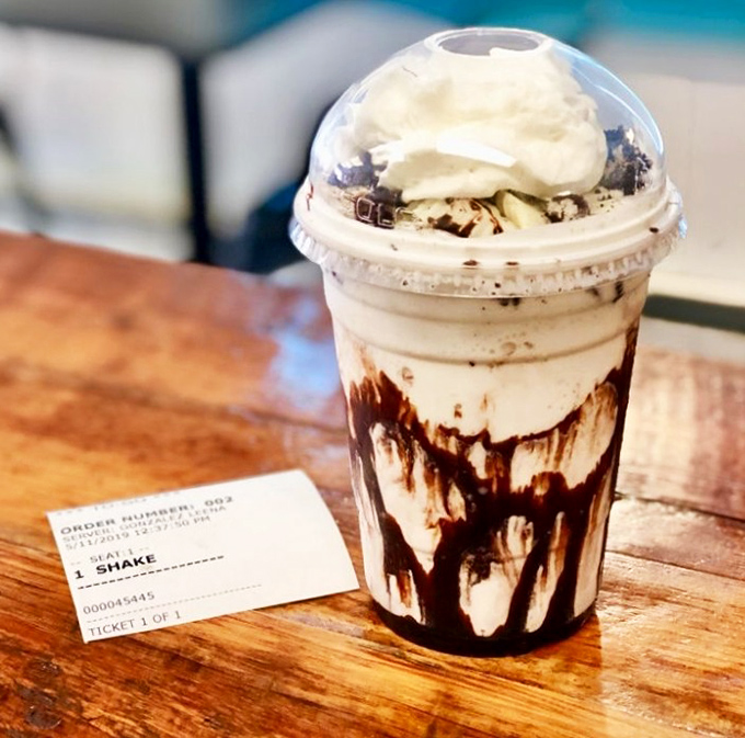 This chocolate shake isn't just a drink&mdash;it's a dessert skyscraper with whipped cream clouds and chocolate syrup rainfall.