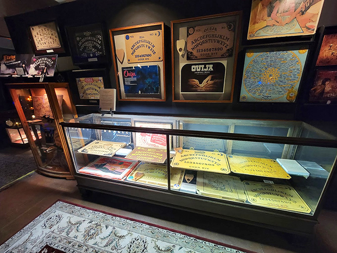 The spirit board collection spans decades of attempts to contact the beyond, arranged with the kind of reverence usually reserved for first-edition books or vintage wine collections.