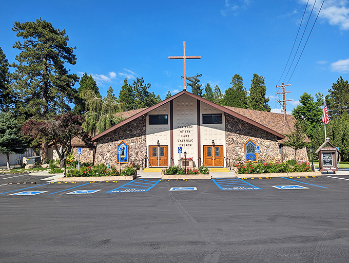 Our Lady of the Lake Parish stands as a spiritual sanctuary amid the pines, its stone facade and cross reaching skyward like the surrounding trees.