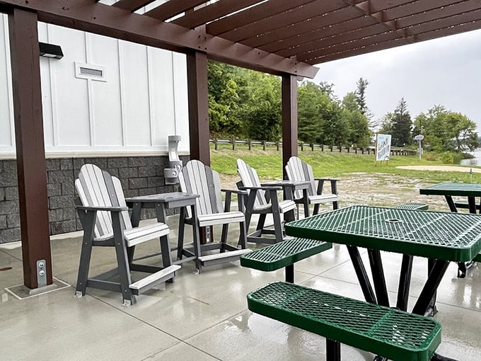 Adirondack chairs positioned at the exact angle where relaxation becomes mandatory, not optional.