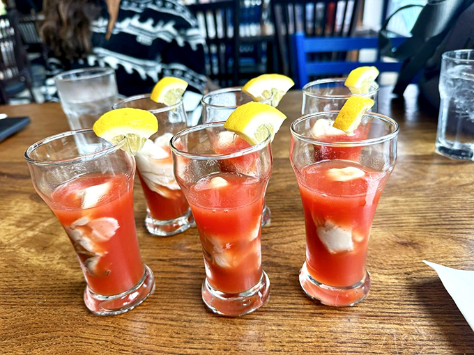 Oyster shooters lined up like tiny aquatic soldiers &ndash; each glass a perfect three-sip symphony of briny oyster, tangy cocktail sauce, and the bright punctuation of lemon.