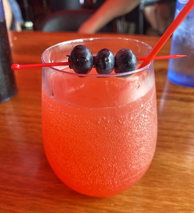 This isn't just a morning cocktail; it's a sunrise in a glass with blueberries standing by like tiny lifeguards watching over your breakfast swim.