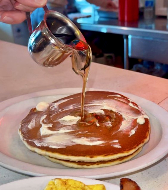 Watch as liquid gold cascades over a perfect pancake &ndash; a moment of breakfast theater that never fails to quicken the pulse.