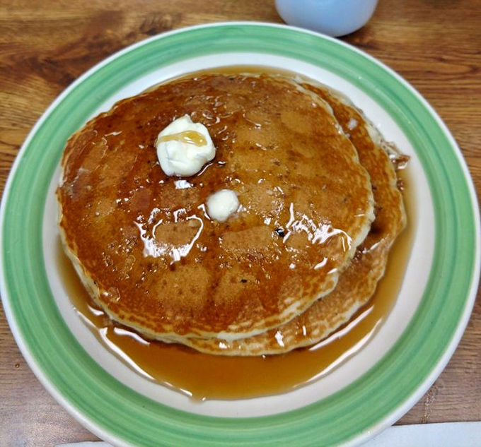 These pancakes aren't just breakfast, they're an edible pillow of happiness topped with melting butter and maple syrup rivers.