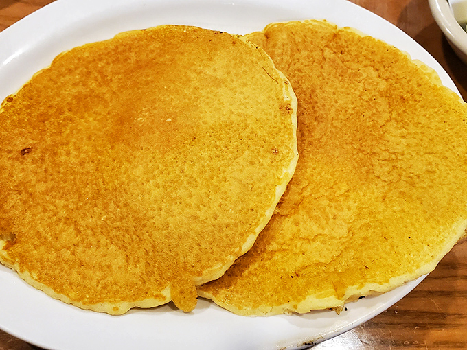 Golden pancakes that look like they've been practicing for their close-up. Fluffy, perfect circles of breakfast joy.