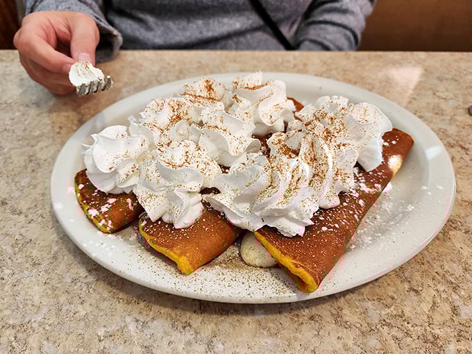 These pancakes aren't just topped with whipped cream&mdash;they're wearing a cloud that's been dusted with cinnamon for good measure.