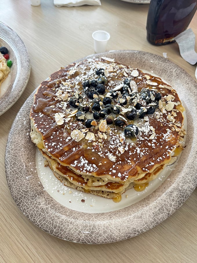 Pancakes topped with blueberries and nuts&mdash;architecture so beautiful you almost feel guilty dismantling it. Almost.