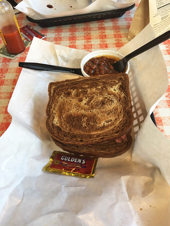 Rye bread struggling nobly under the weight of perfectly smoked pastrami and baked beans. A beautiful relationship of bread and meat.