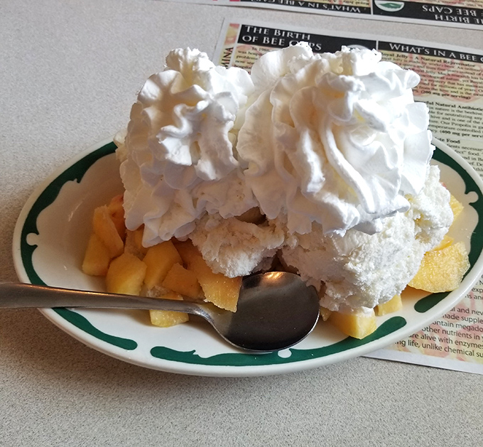 Peach shortcake topped with whipped cream clouds that could make summer last all year long.