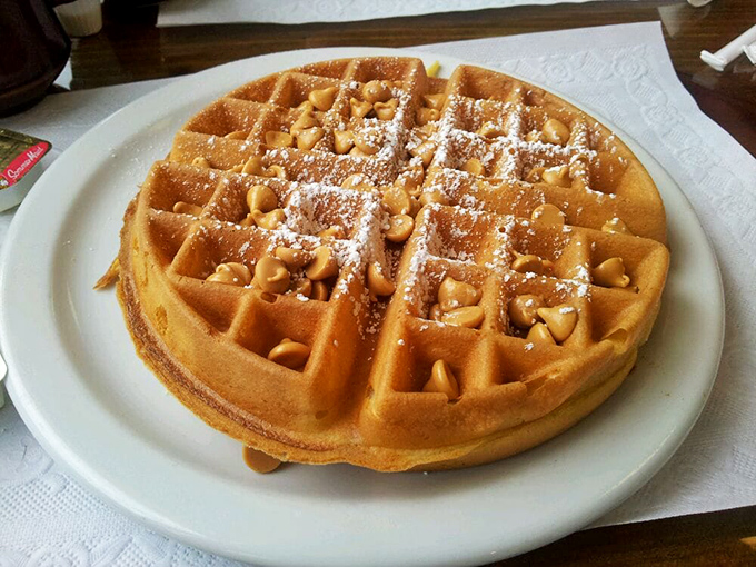 Waffle perfection: golden squares creating perfect pockets for melted peanut butter chips and a dusting of powdered sugar. Breakfast or dessert? Yes.