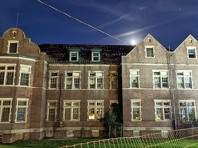 Moonlight transforms Pennhurst into something from a gothic novel, the illuminated windows hinting at activities within that contrast sharply with its past.
