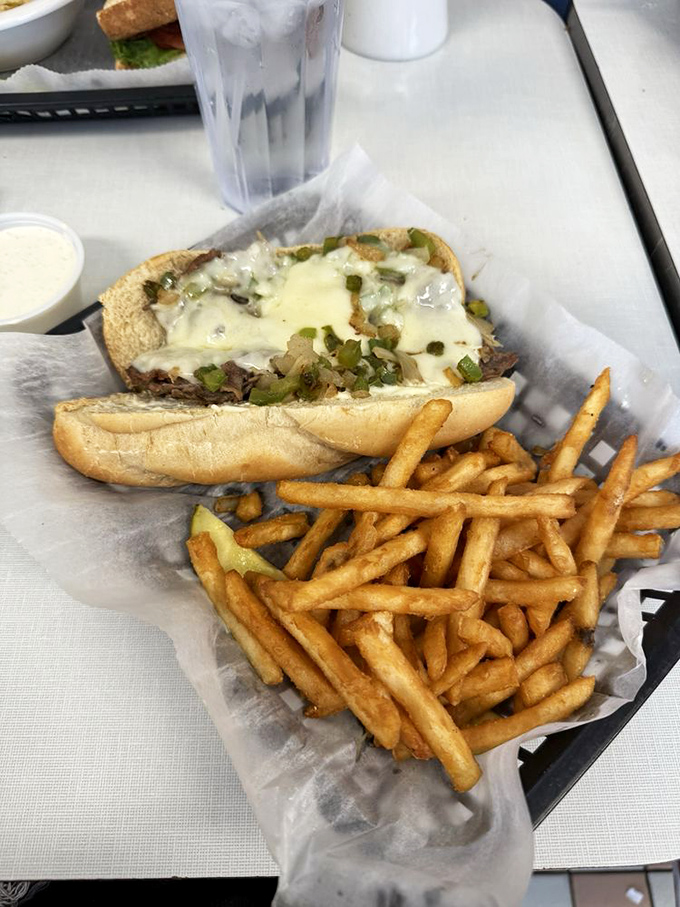 A Philly cheesesteak that would make a Philadelphian nod in respectful approval, paired with fries that deserve their own fan club.