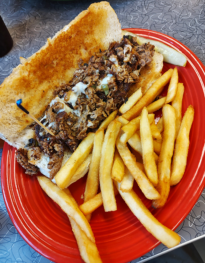 This isn't just a sandwich&mdash;it's a Philly masterpiece on a red plate runway, escorted by a golden honor guard of perfect fries.