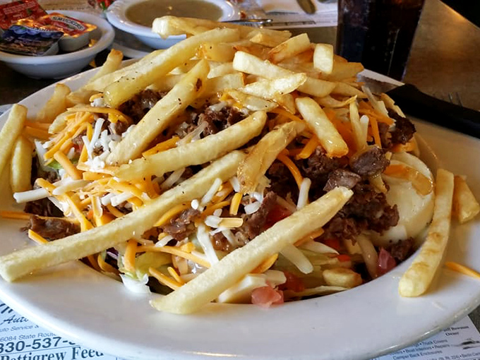 A mountain of crispy fries topped with steak, cheese, and veggies &ndash; it's what happens when a Philly cheesesteak and salad have a delicious identity crisis.