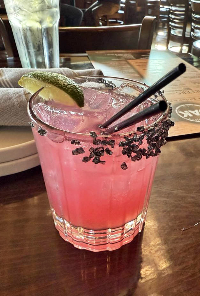The pickled pear margarita isn't just a drink, it's a conversation piece&mdash;vibrant pink with a black salt rim that's as Instagram-worthy as it is delicious.