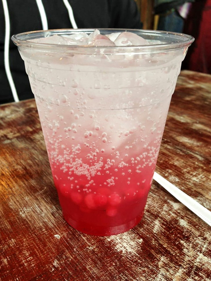 That vibrant red beverage isn't just a drink&mdash;it's liquid refreshment art, bubbling with possibilities and the perfect counterpoint to biscuit richness.