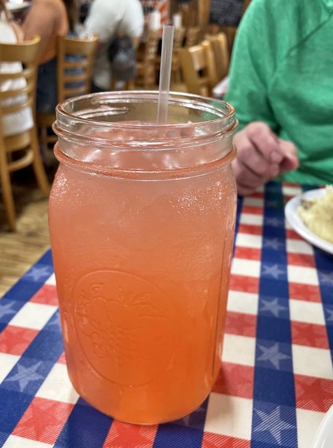 That mason jar isn't just holding pink lemonade; it's containing summer in liquid form, ready to cut through the richness of fried seafood.