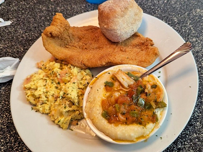 Southern breakfast trinity: golden fried chicken, fluffy scrambled eggs, and grits that could make a Northerner finally understand what all the fuss is about.