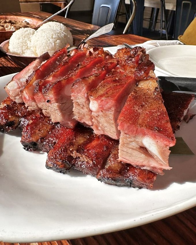 Pork ribs sliced with surgical precision, glistening with caramelized perfection. The kind of meat that makes vegetarians nervously reconsider their life choices.