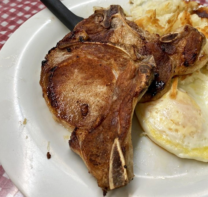 This pork chop isn't just cooked &ndash; it's respected. Sitting alongside those sunny eggs and hash browns, it's the breakfast trifecta of champions.