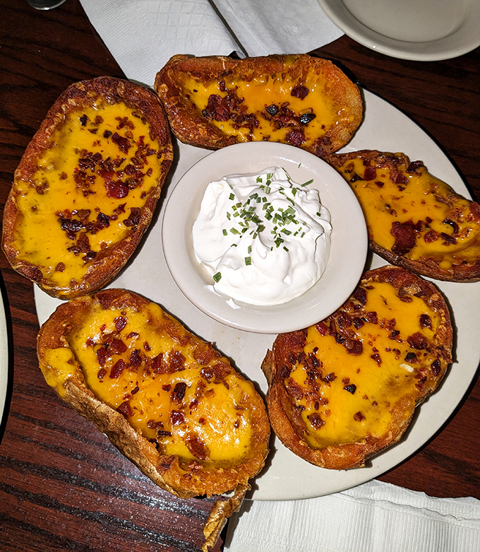 Potato skins that achieve the perfect trifecta: crispy edges, tender centers, and generous toppings. The kind that disappear from the plate while everyone claims they're "too full."